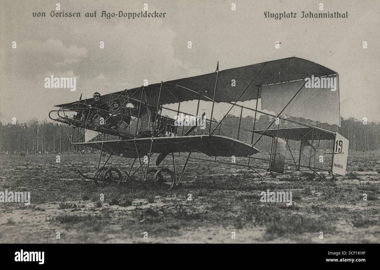 A German biplane with two pilots inside, seen on a field in ...