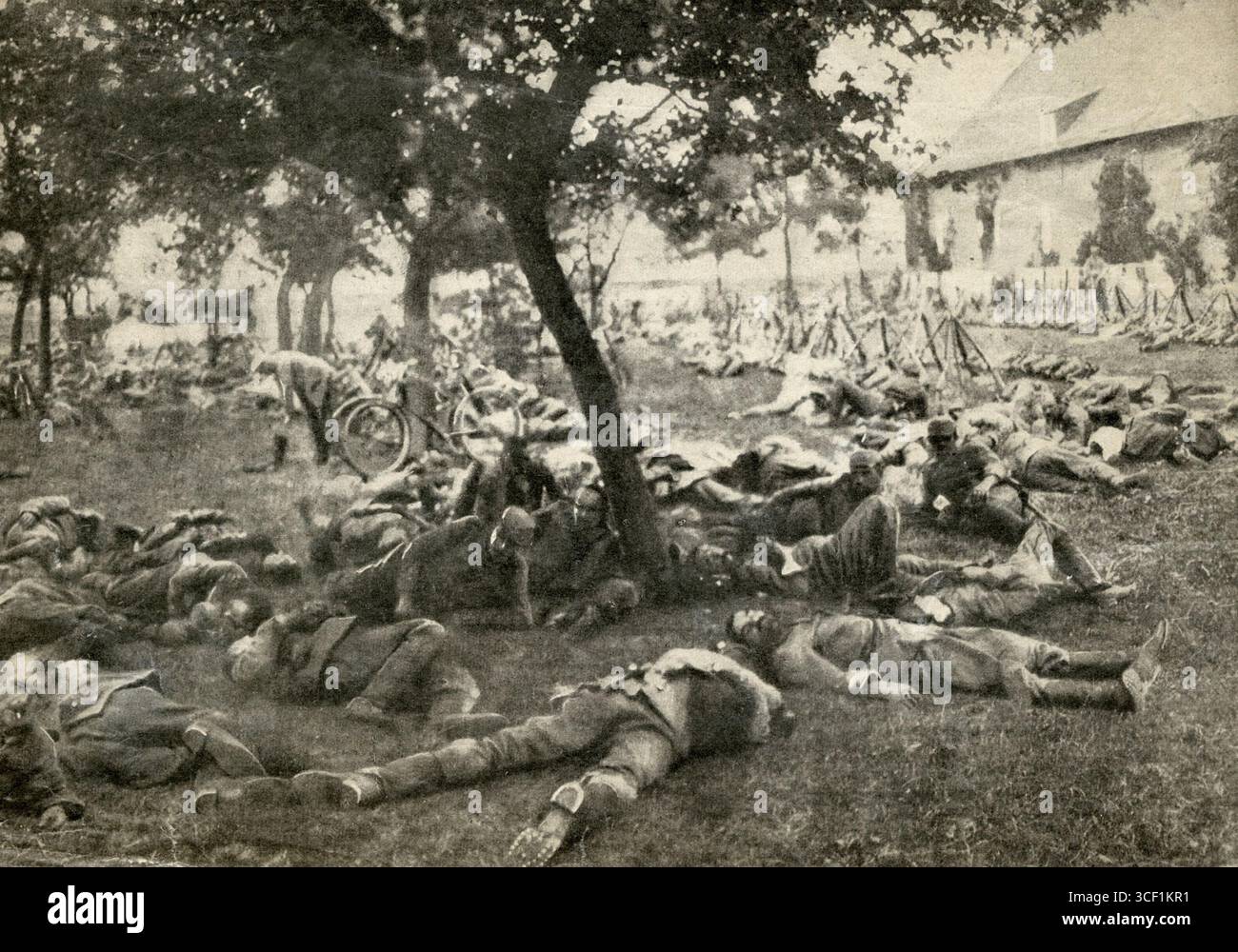 During World War I, tired German soldiers rest on a grassy field in ...
