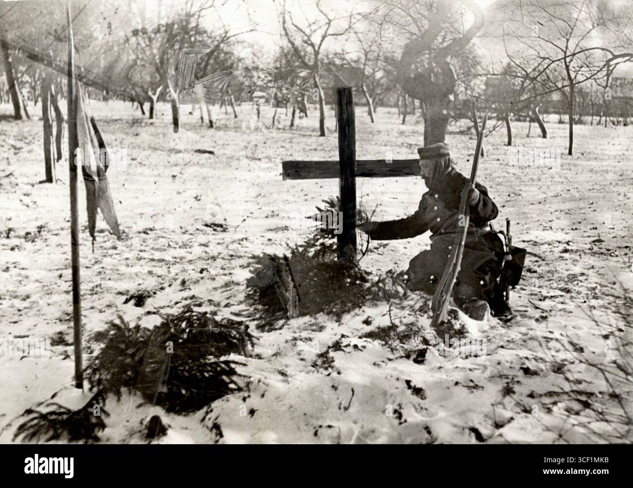World War I, 1914. A German soldier places branches of a Christmas tree ...