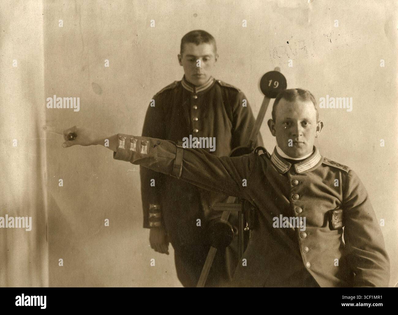 In 1915, a wounded soldier performs bending and stretching exercises on ...