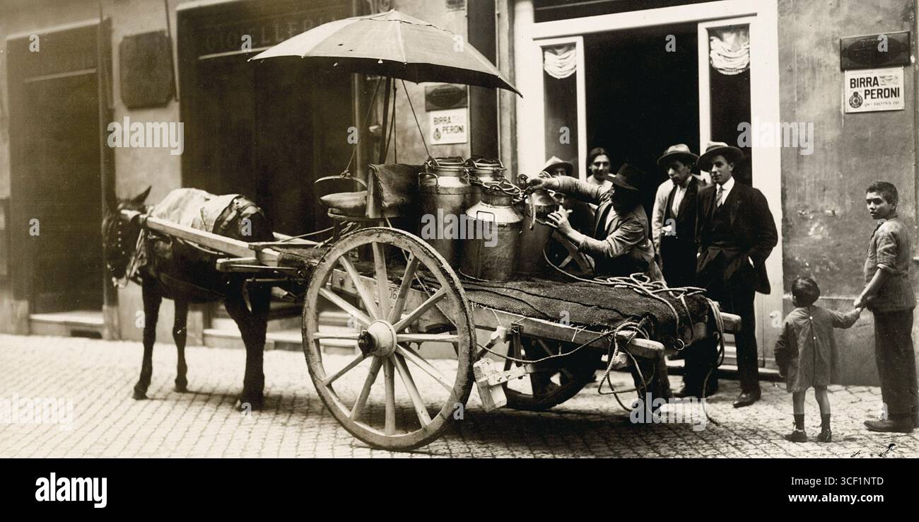 In 1925, a milk vendor stands beside a horse-drawn cart loaded with ...