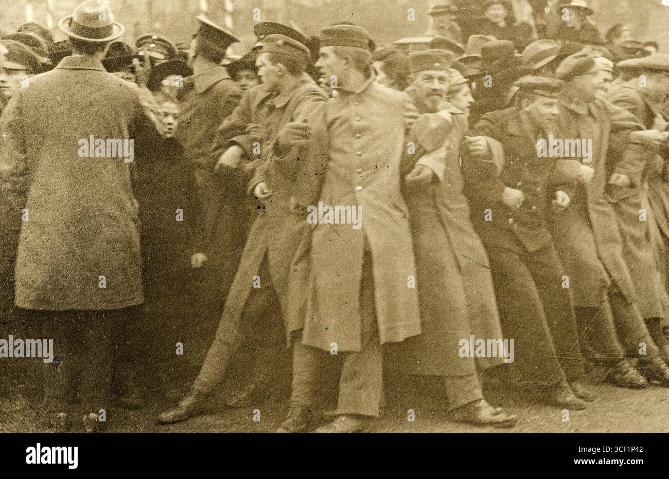 German sailors control an excited crowd during the return of soldiers ...