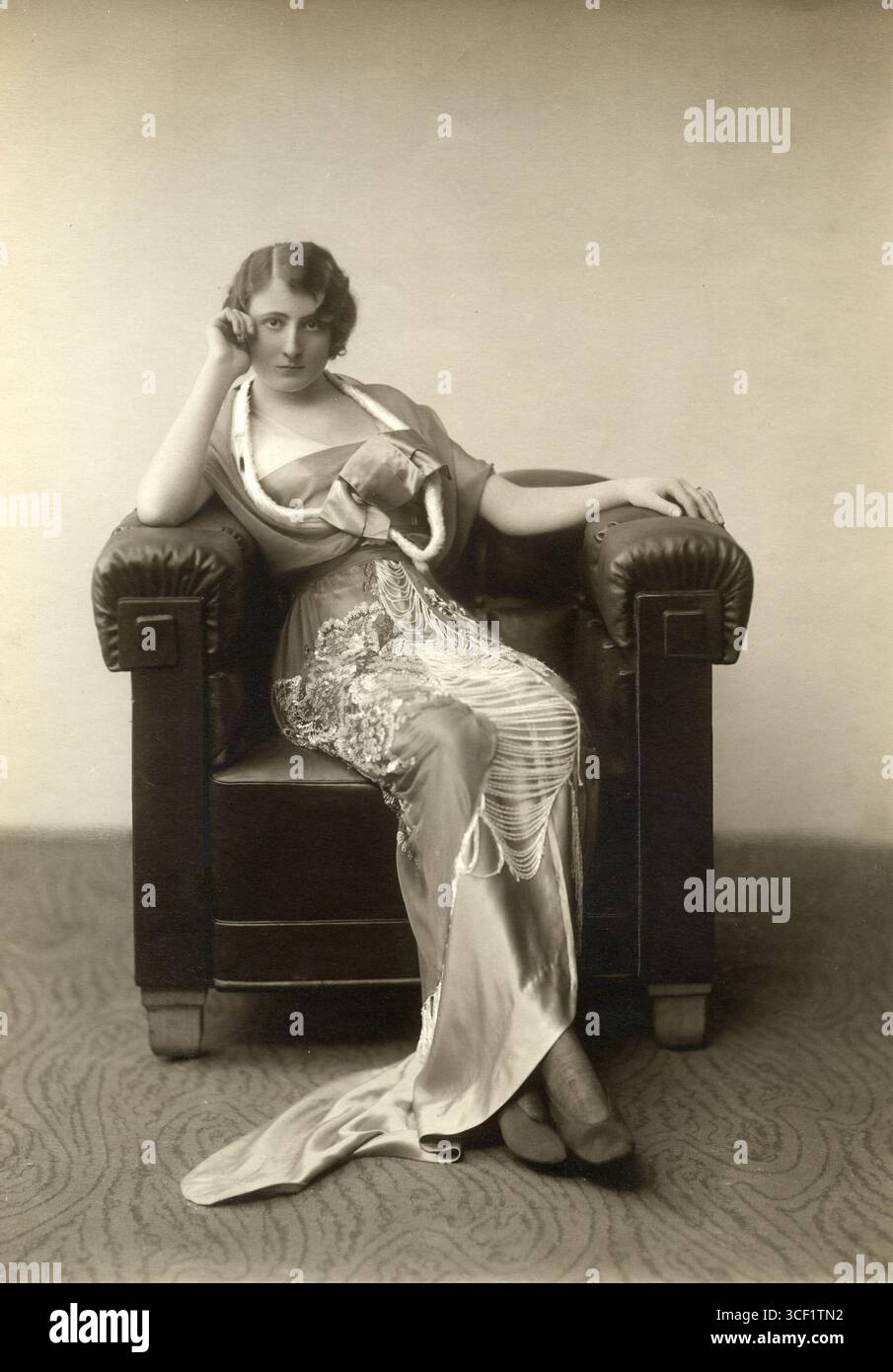 A French mannequin is seated in a chair, captured in an unknown ...