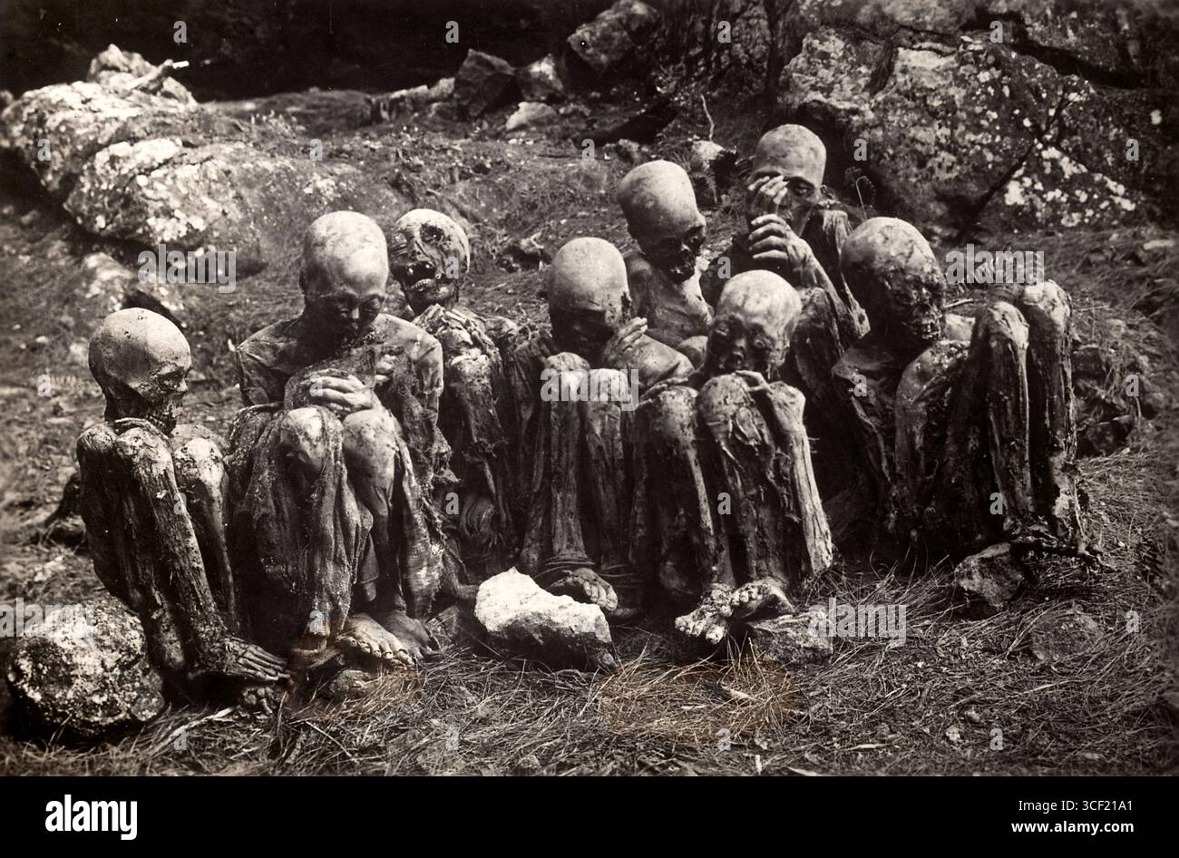 A group of mummified bodies from Luçon, Philippines, is displayed. The ...