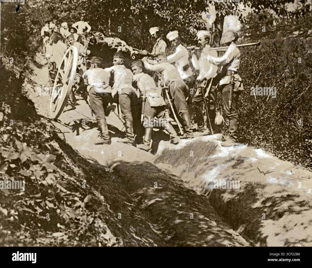 Serbian mountain artillery soldiers push a cart along nearly impassable ...