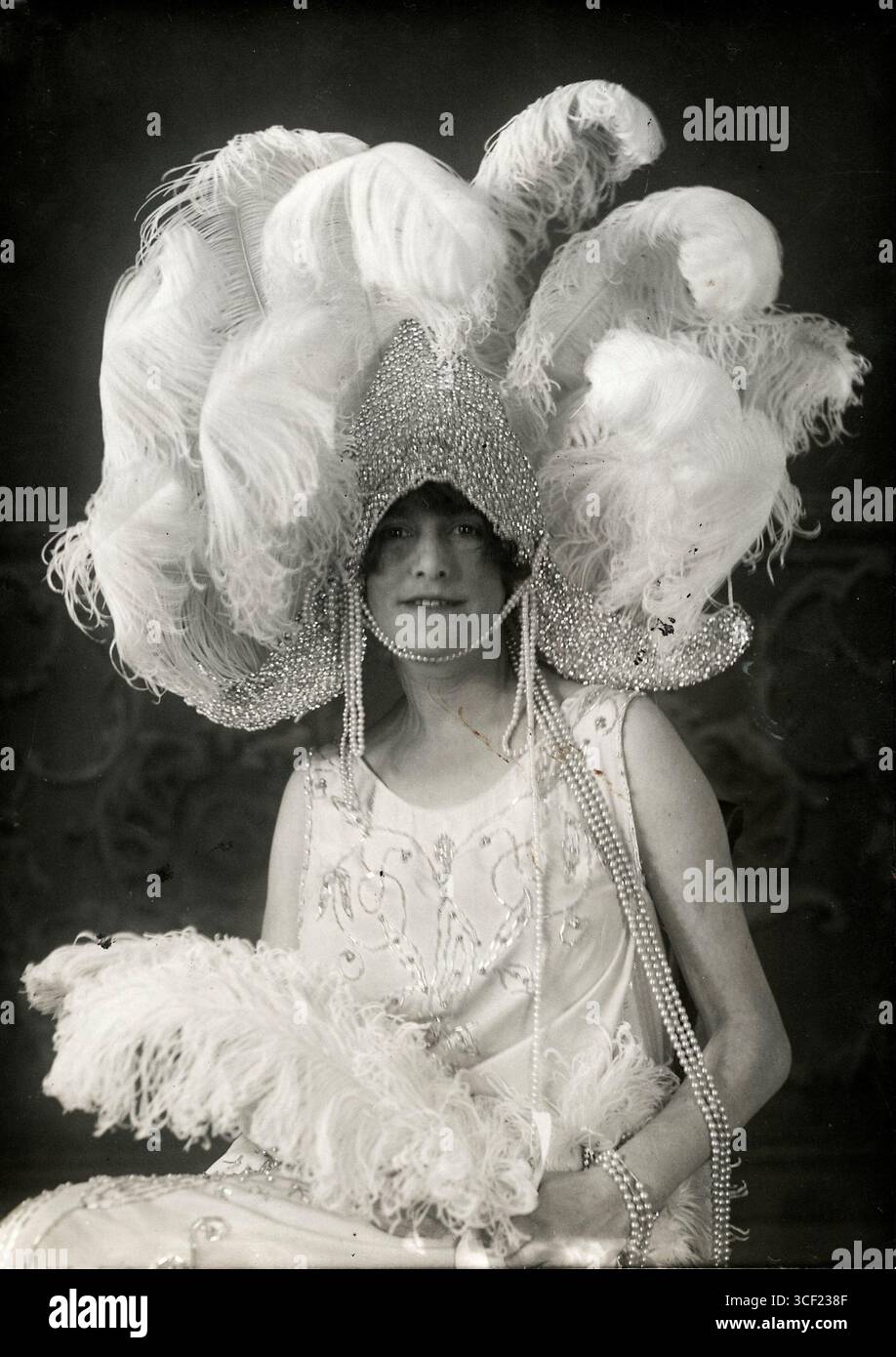 English artist Bessie Lee wears an elaborate headpiece made of ostrich ...