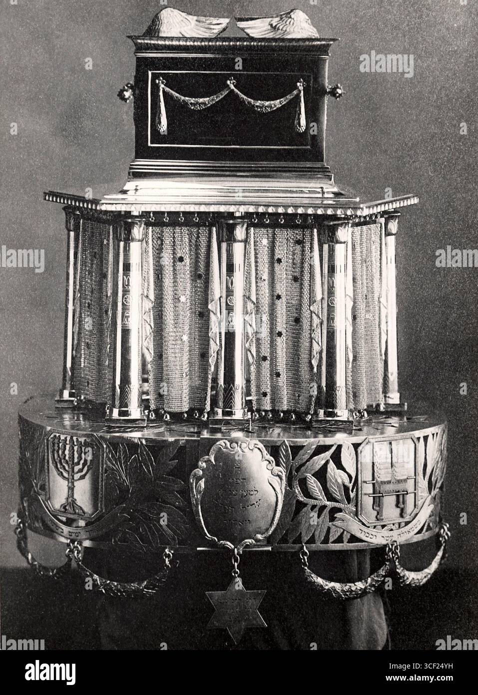 This image shows the crown of a Torah scroll, featuring the depiction ...
