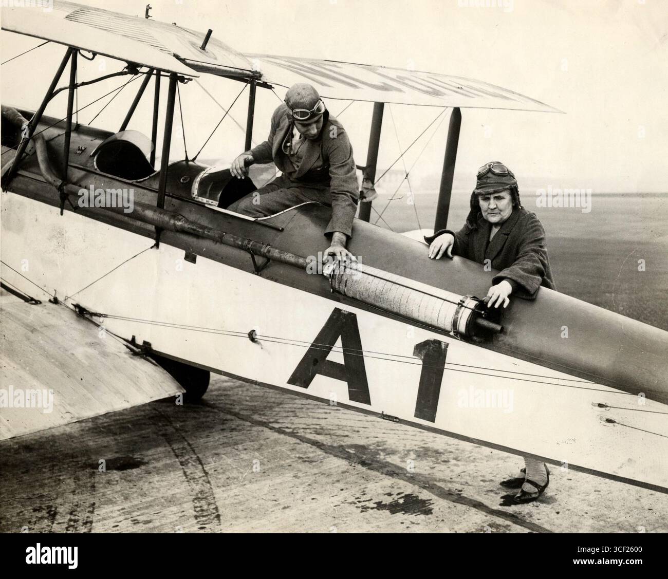 This 1930 image shows a silent aircraft with a pilot. Mrs. Jones, who ...