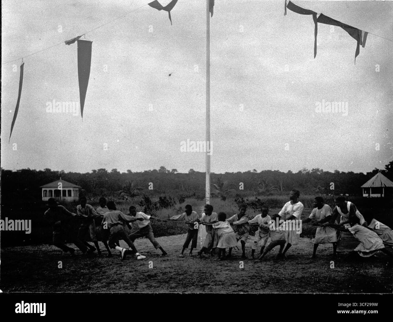 This photo from April 30, 1927, captures children playing tug-of-war ...