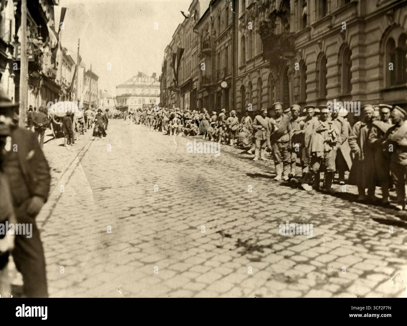 Captured Russian soldiers rest on the street in Zarnów, Poland, in 1915 ...