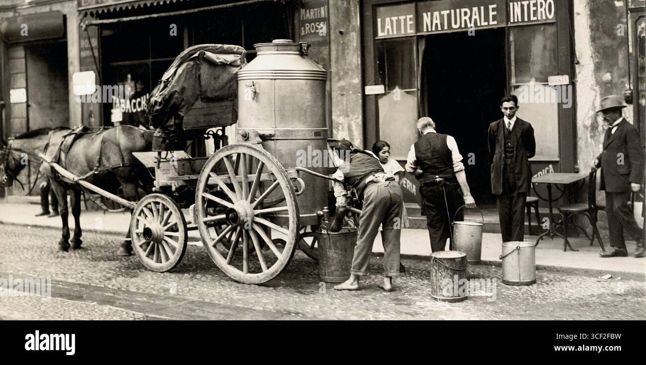 In this 1925 photograph, a milk seller is seen pouring milk from a ...