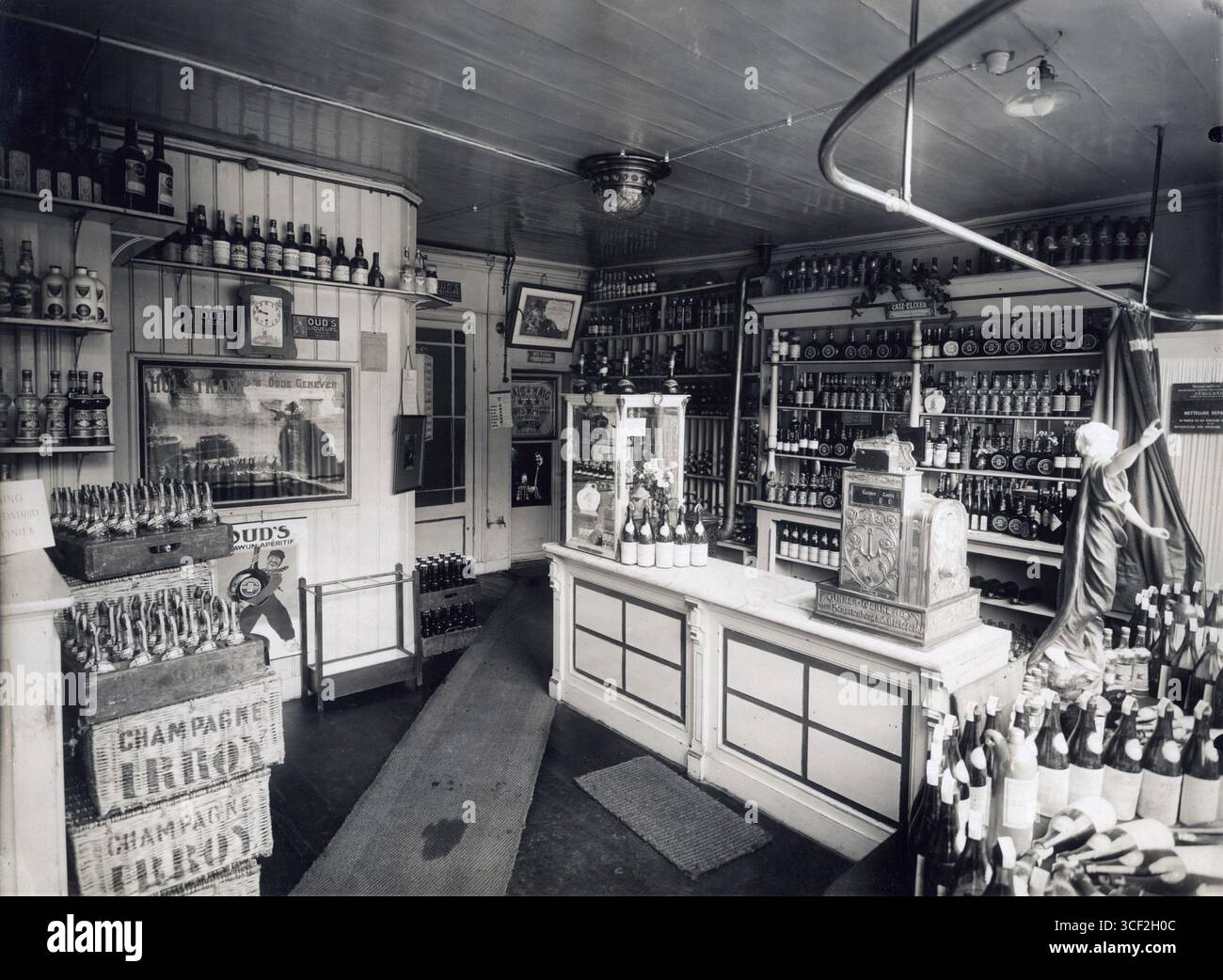 The interior of a liquor store in Amsterdam in 1918 is shown, depicting ...