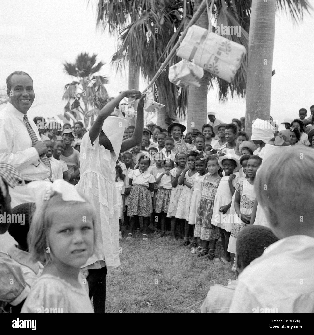 A 1951 negative showing children playing 'pakjes knippen' (a game ...