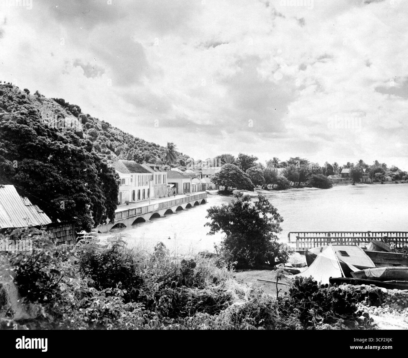 A 1947 reprint negative depicting the waterfront of Marigot, offering a ...
