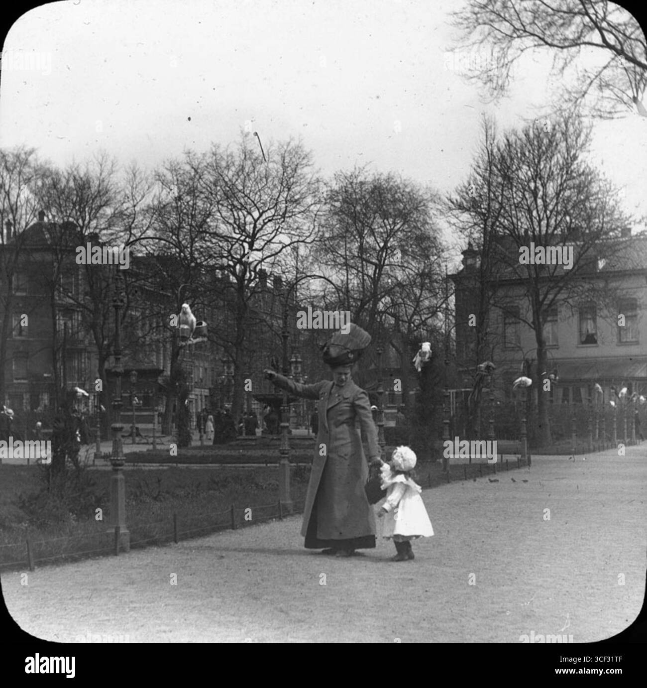 A photograph from between 1900 and 1920 showing a mother and child at ...