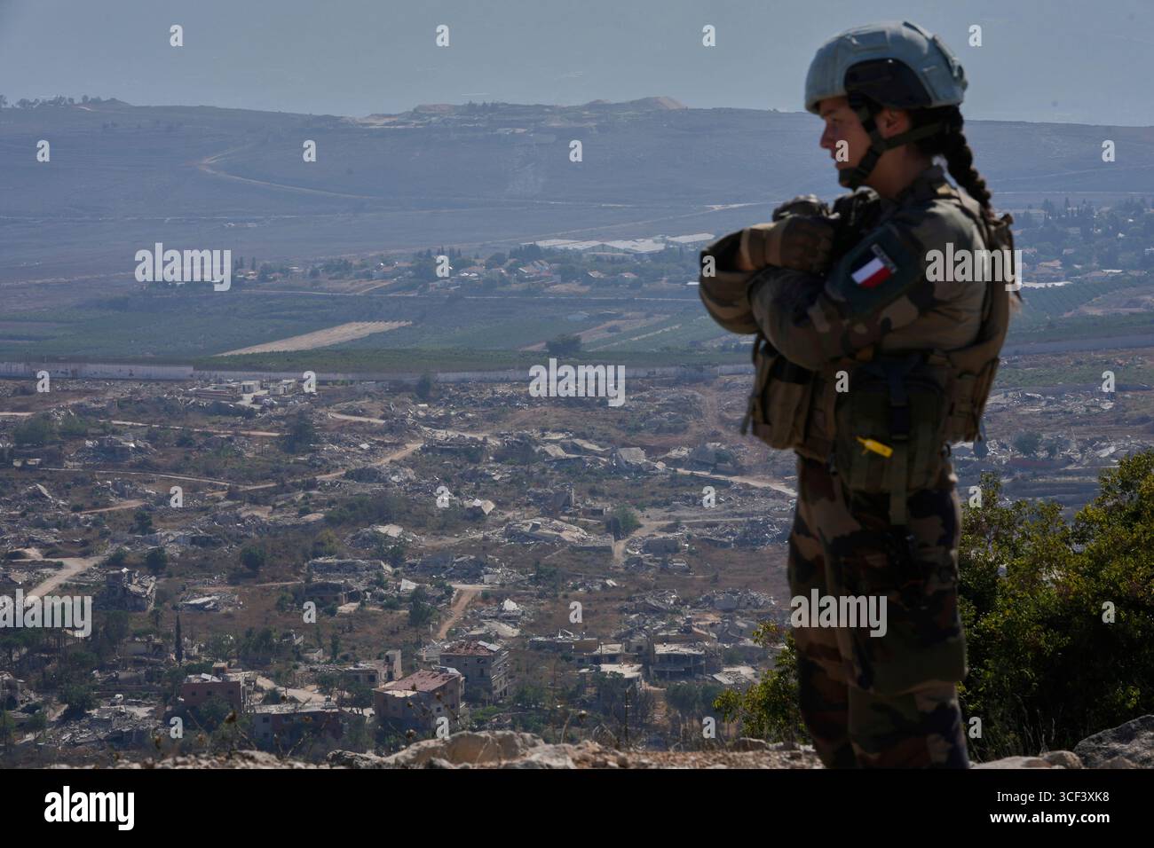 A French U.N. peacekeeper stands on a hill overlooking Kfar Kila, a ...