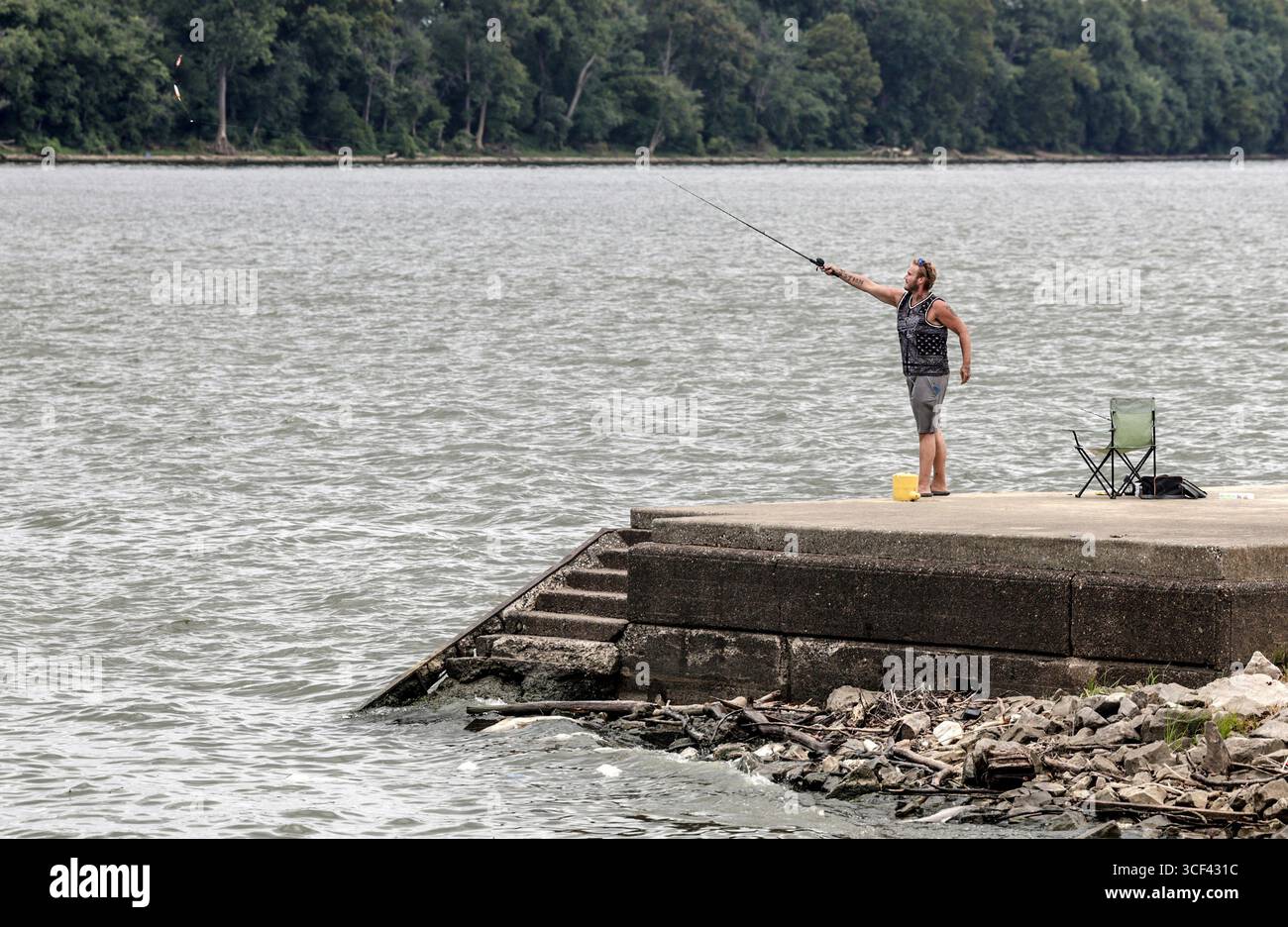 Dustin Taylor of Lewisport, Ky, casts a line out over the Ohio River ...