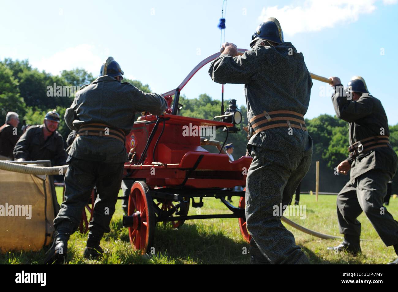Firefighters operate vintage horse-drawn fire pump during traditional ...