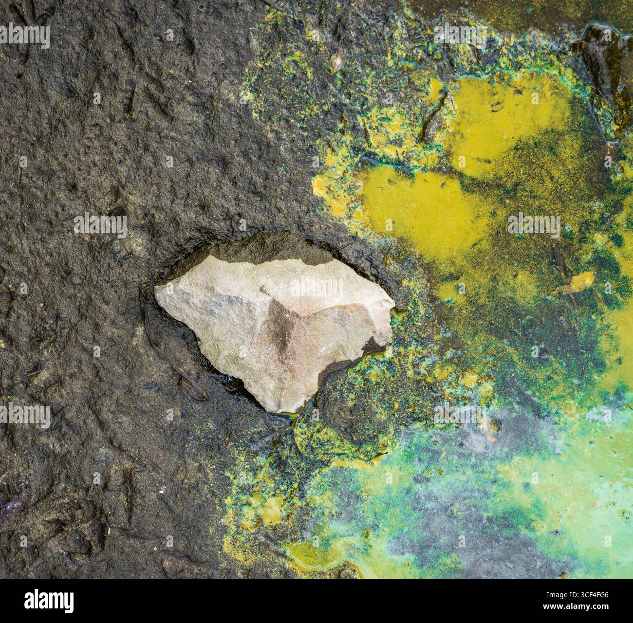 Colorful toxic waste creating abstract patterns in polluted water, with ...