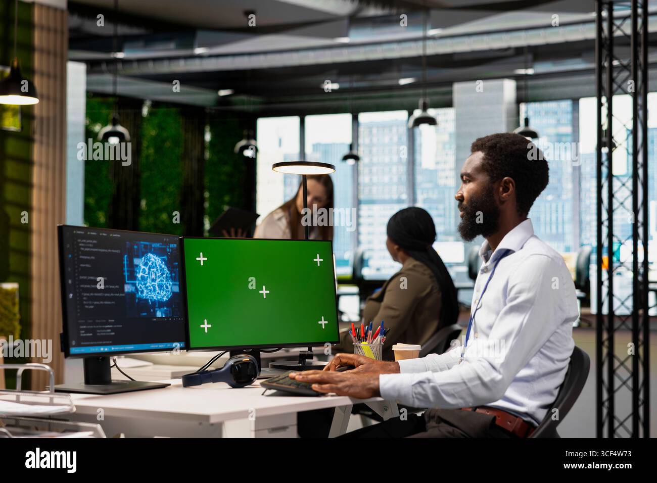 Technician using green screen PC to code, testing AI applications to ...