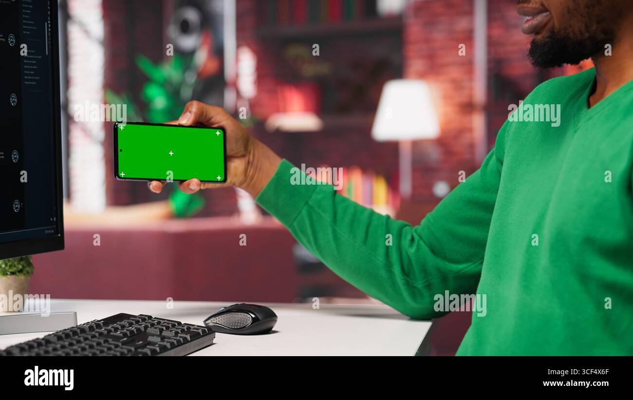 African american man engaging with AI chatbot next to chroma key, using ...