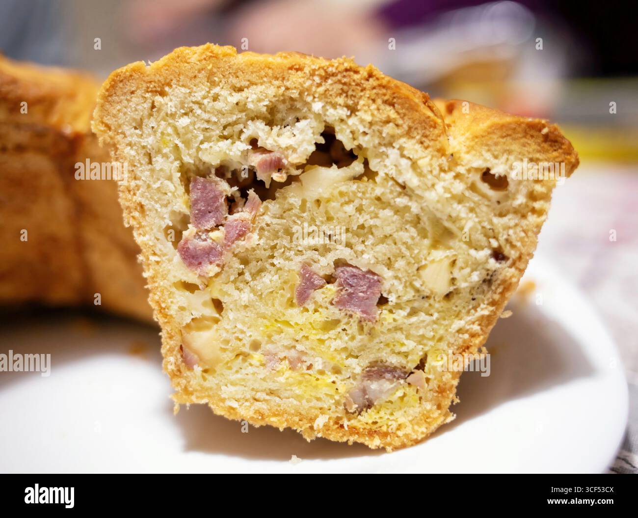 Close up of Neapolitan tortano slice, showcasing chunks of cheese and ...