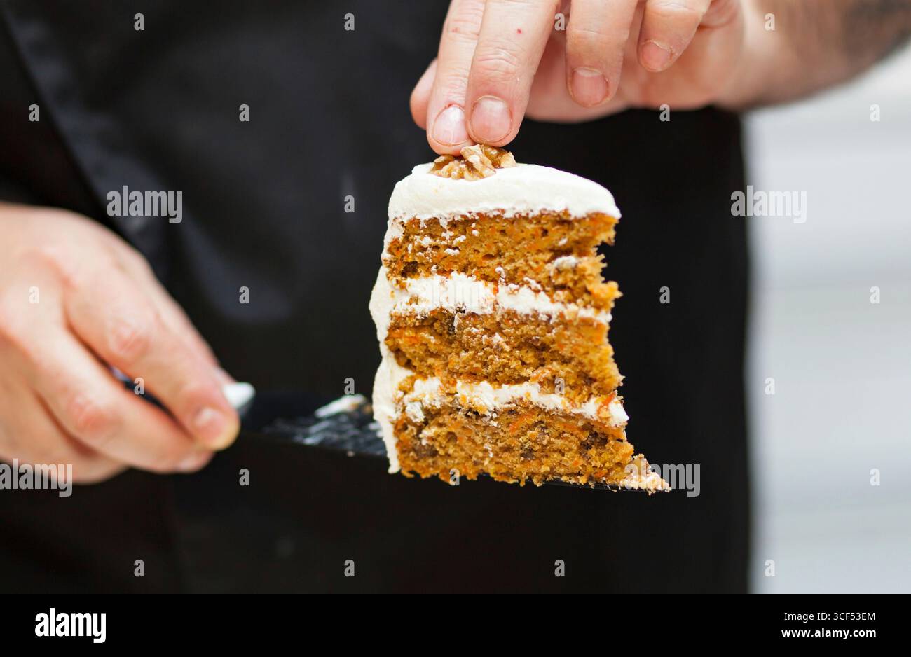 Carrot cake with cream cheese frosting and little carrots on top Stock ...