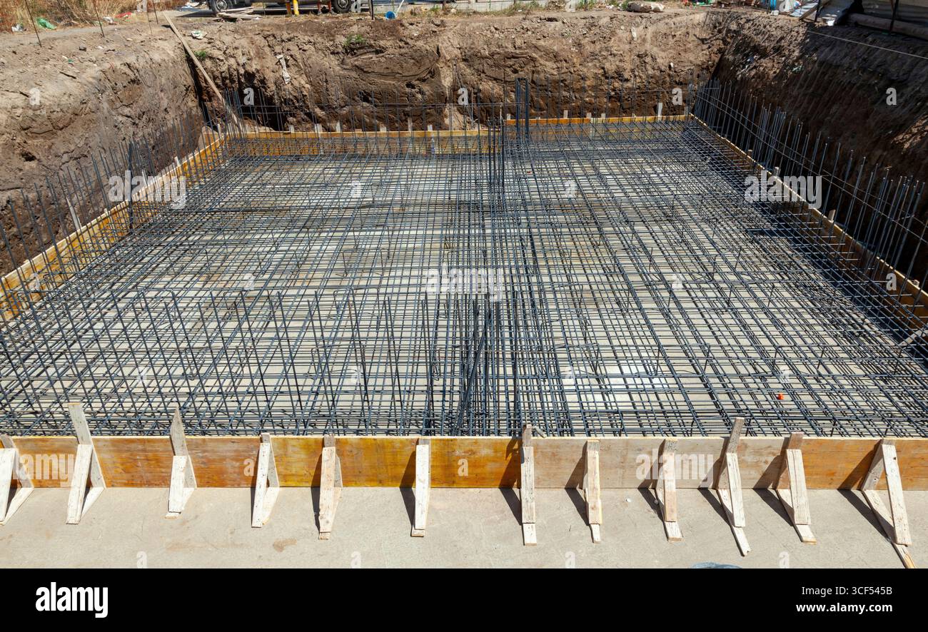 Reinforcing steel bars creating grid structure for concrete foundation ...
