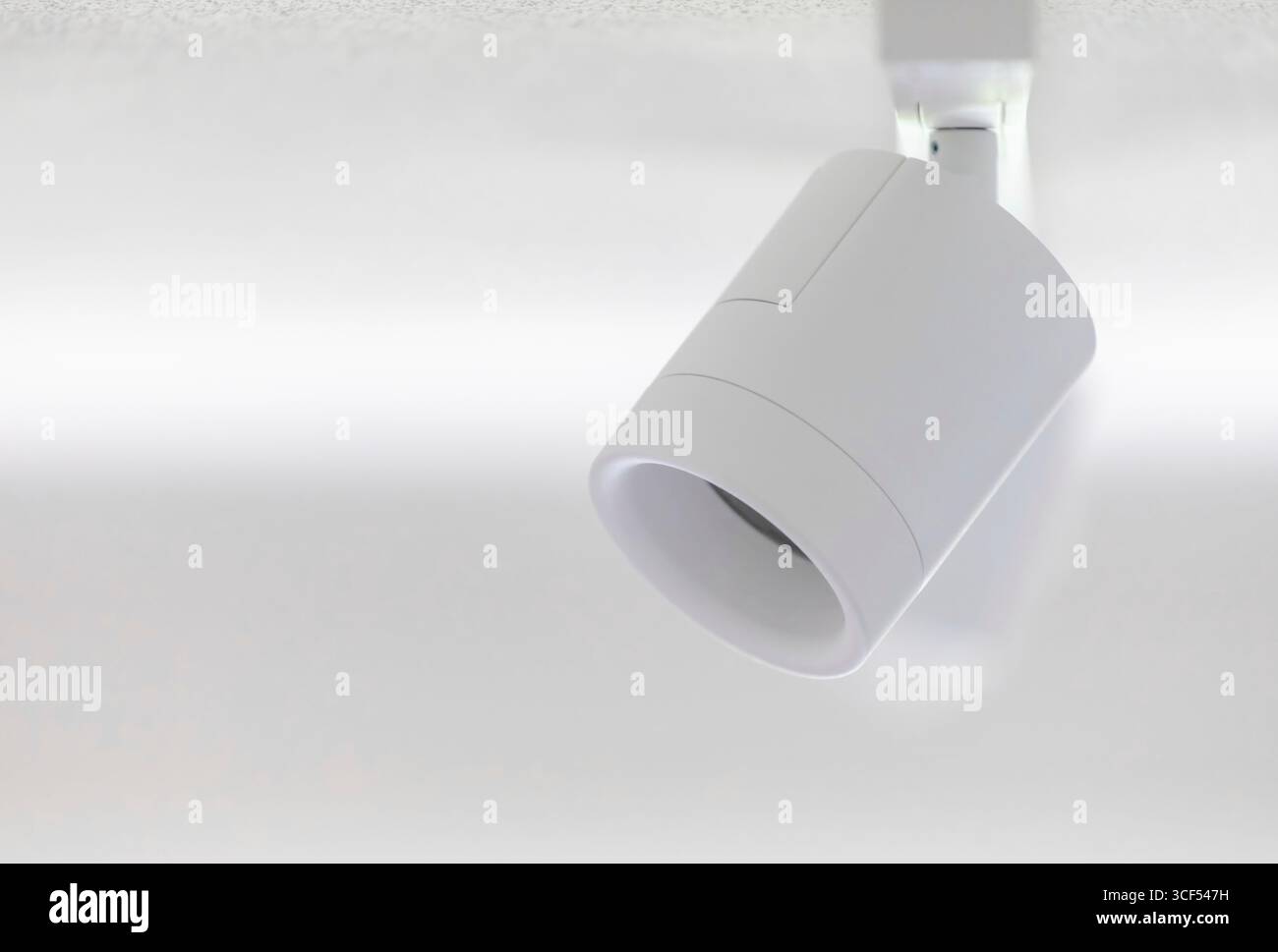 Cylindrical track lighting fixture mounted on a white ceiling hi-res ...