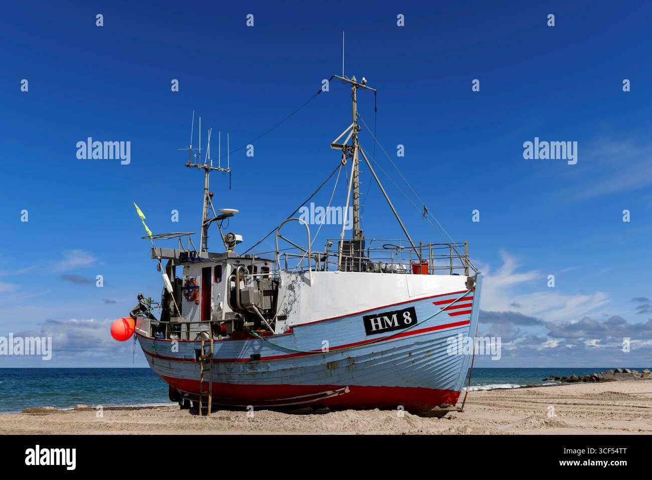 Fishing boat lying on the beach at Thorup Strand, Denmark Stock Photo ...