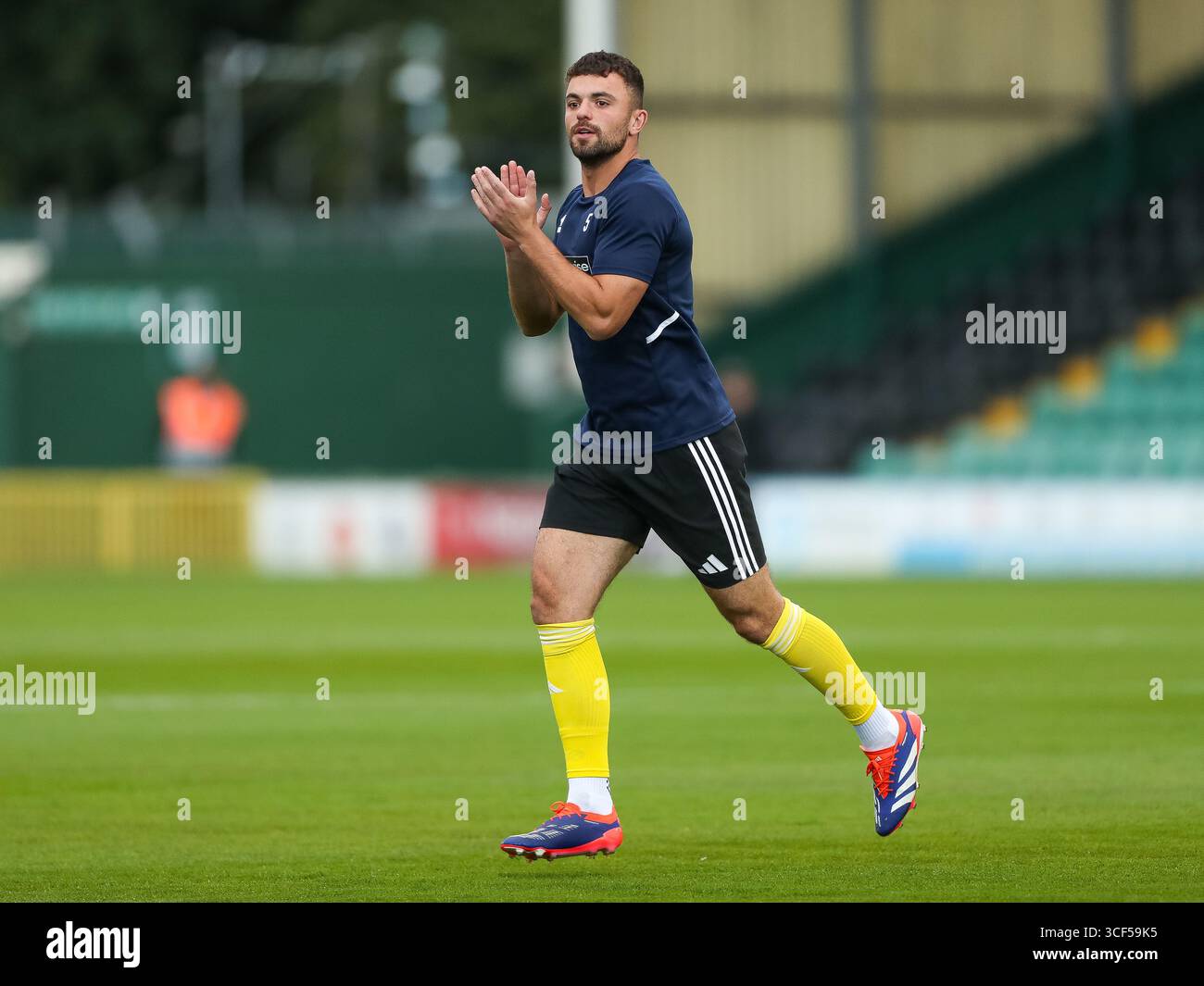 Yeovil, UK. 20th August 2025. Kyle Morrison of Brackley Town claps the ...