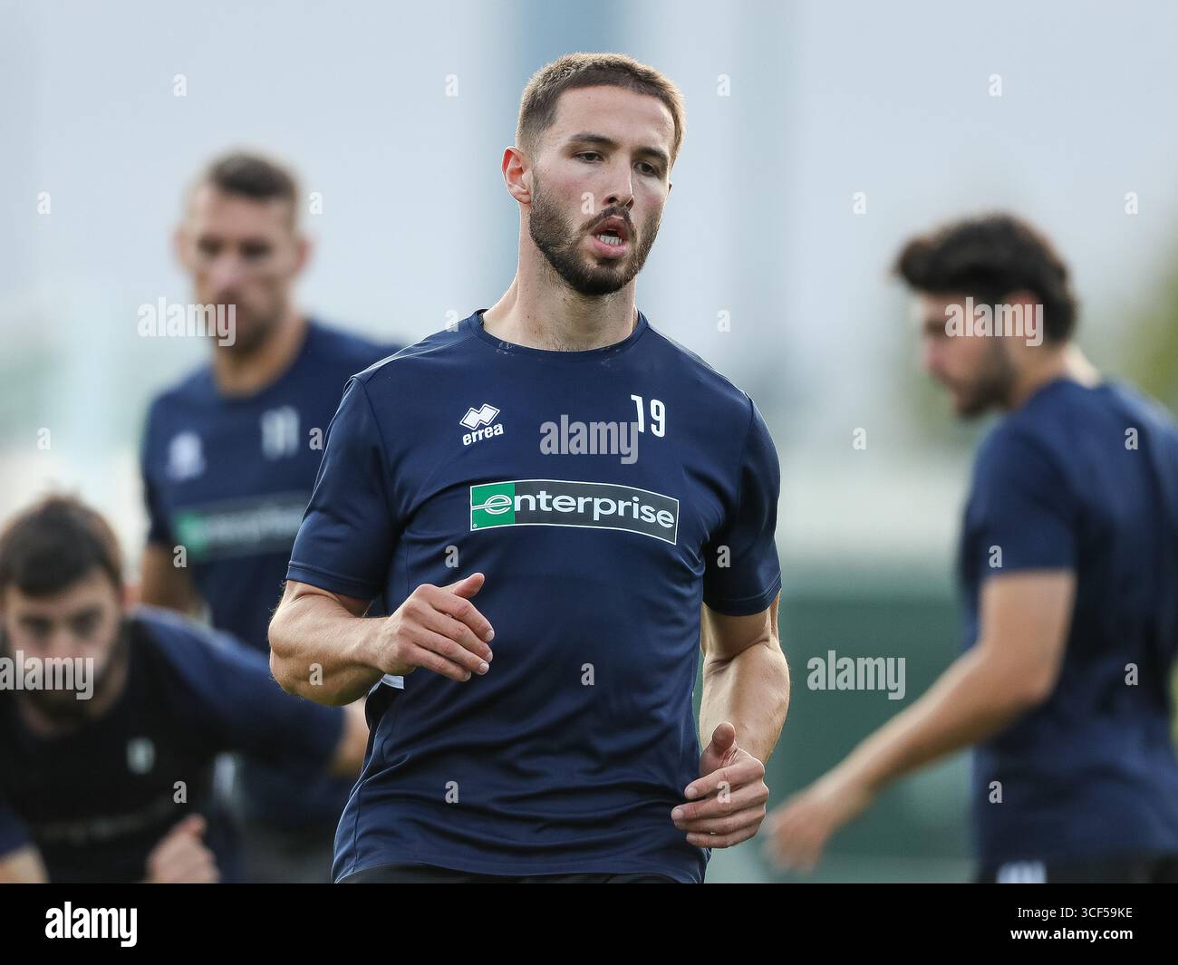 Yeovil, UK. 20th August 2025. Zak Lilly of Brackley Town warms up ...