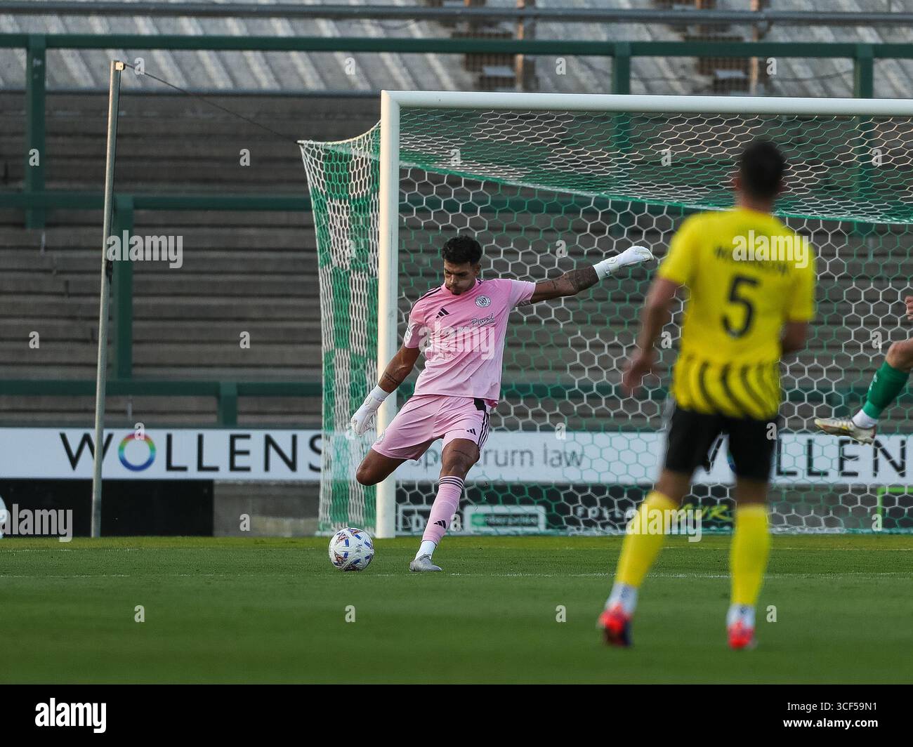 Yeovil, UK. 20th August 2025. Cameron Gregory of Brackley Town clears ...