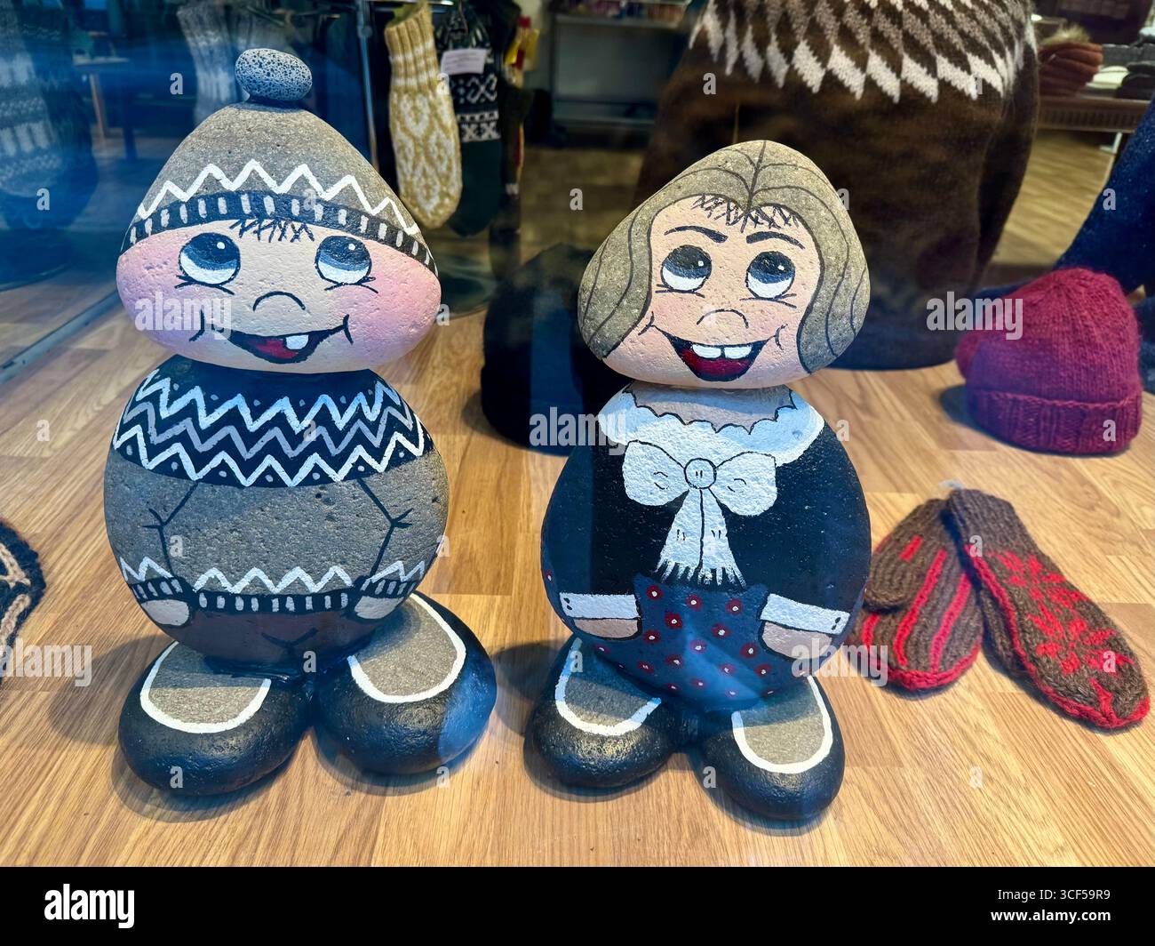 Cute Iceland characters crafted with paint on stones seen in a store ...