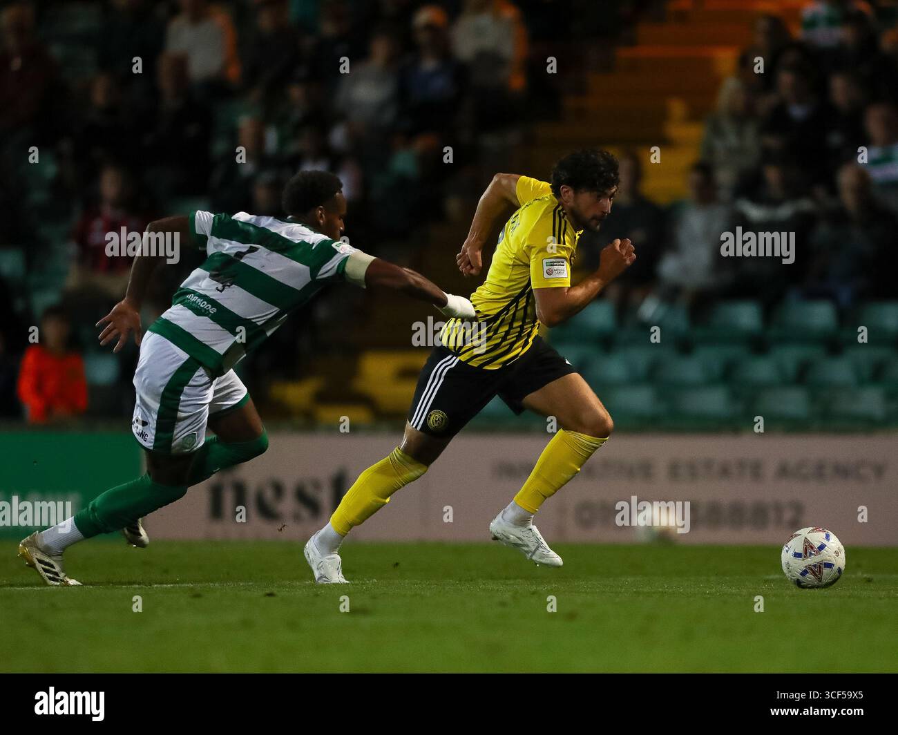 Yeovil, UK. 20th August 2025. Scott Pollock of Brackley Town dribbles ...