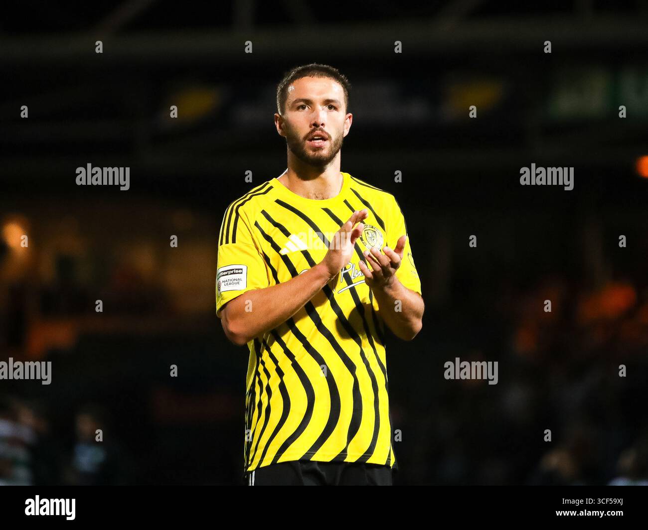 Yeovil, UK. 20th August 2025. Zak Lilly of Brackley Town claps the away ...