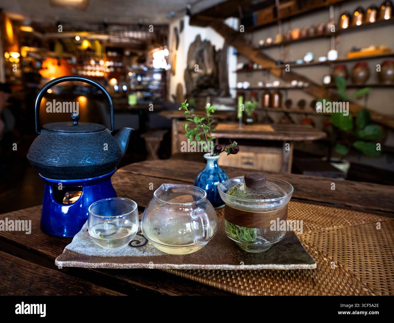 Oolong tea steeping in a glass teapot on a table of a traditional ...