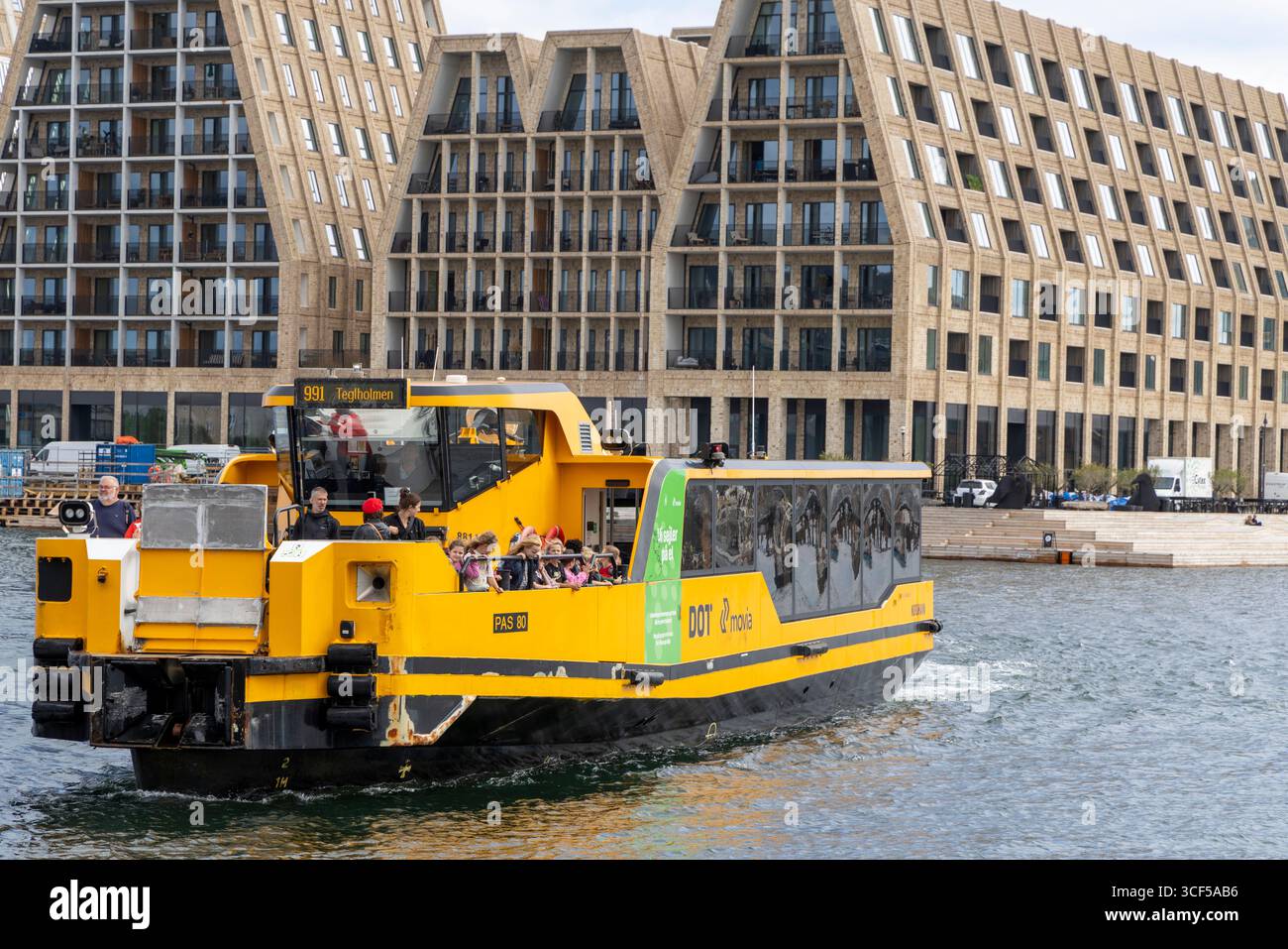 Copenhagen, Denmark, electric yellow harbour bus ferry on inner harbour ...