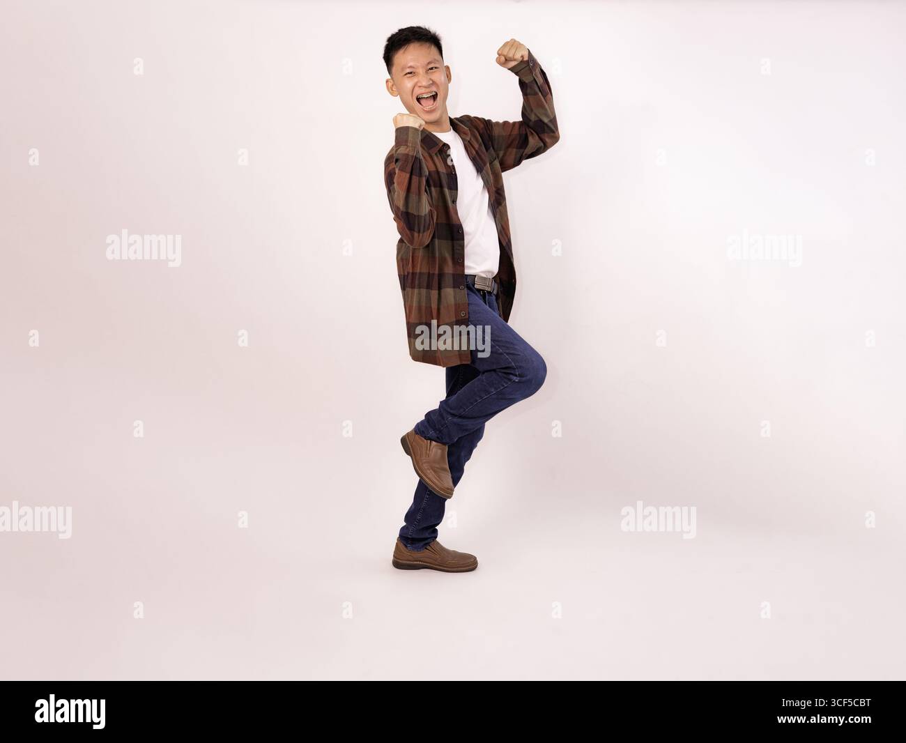 excited man expressing joy with cheerful pose on a light background ...