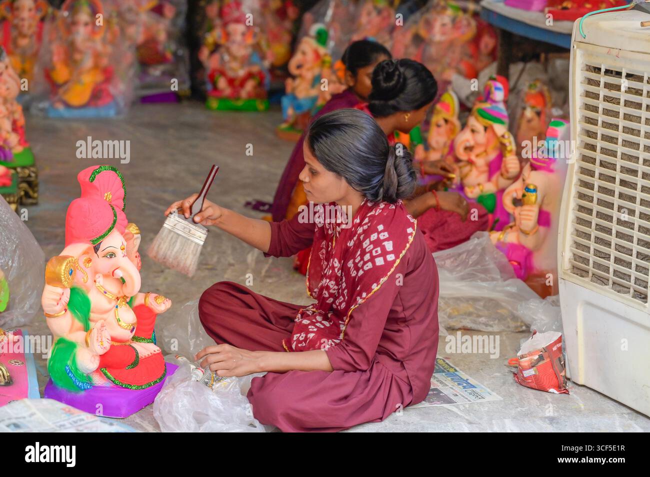 NEW DELHI, INDIA - AUGUST 20: An artist gives finishing touches to ...
