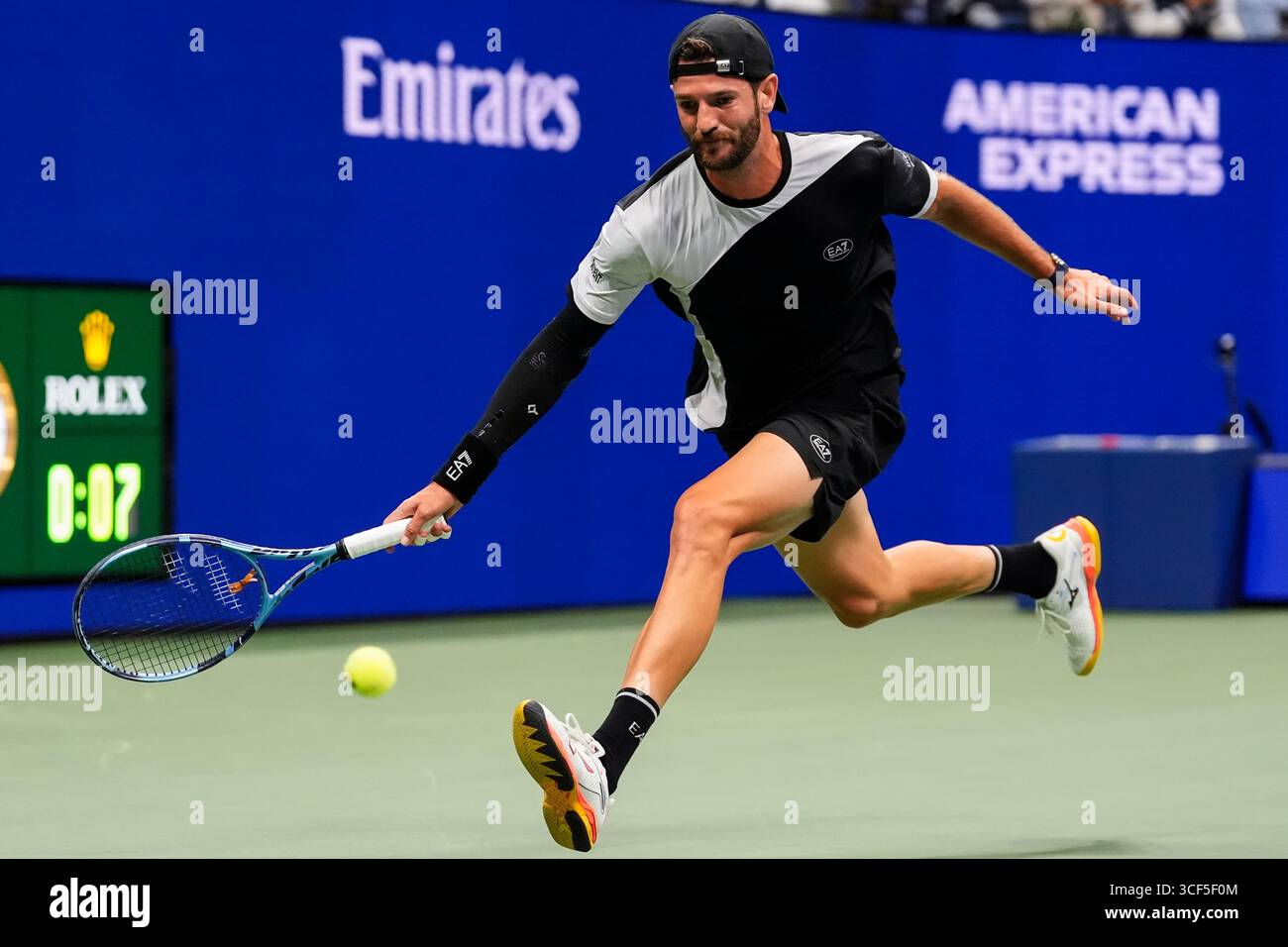 Andrea Vavassori, of Italy, returns a shot during the mixed doubles ...
