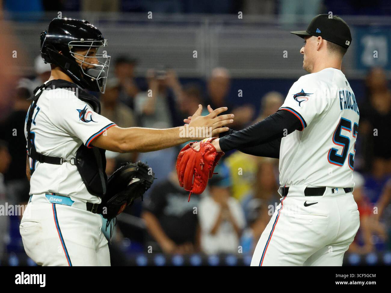 Miami Marlins catcher Agustin Ramirez, left and relief pitcher Calvin ...