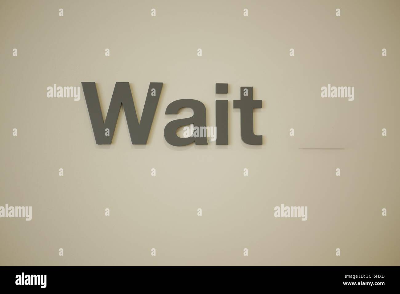 Focus on the word wait on a simple background Stock Photo - Alamy