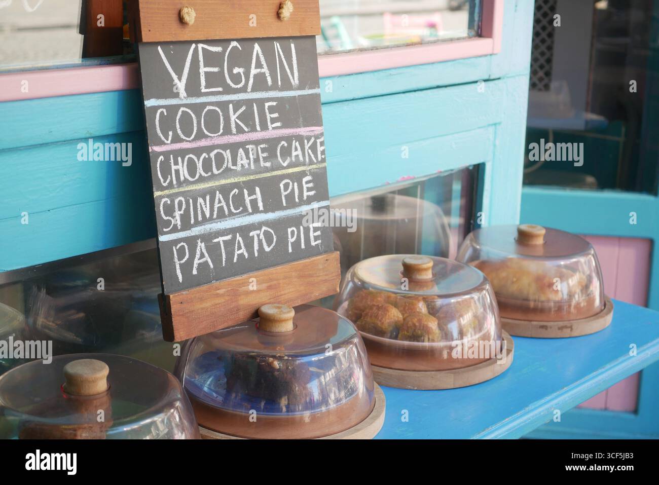 Vegan dessert offerings at a colorful cafe bakery display Stock Photo ...