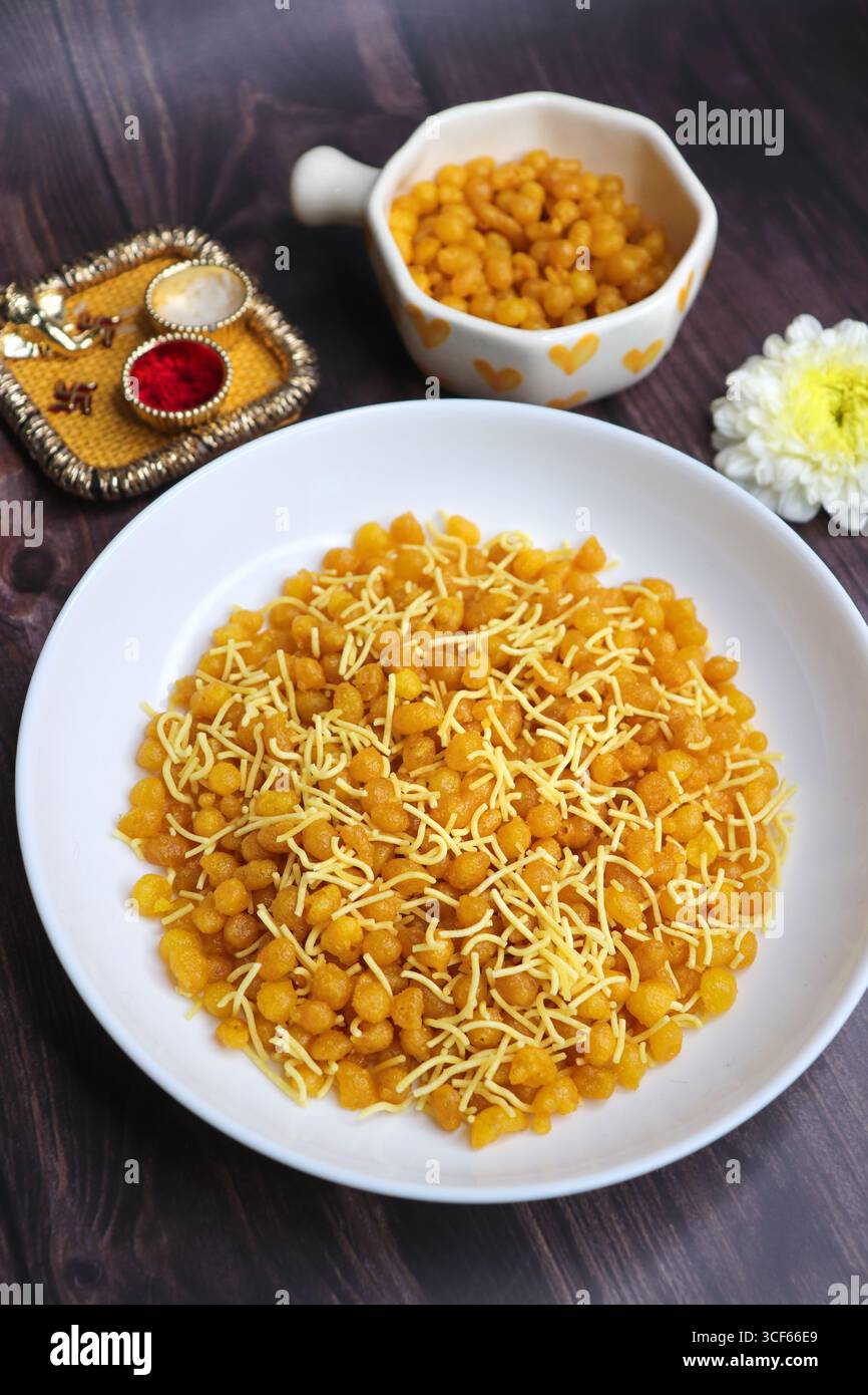 A close up of traditional Indian snacks. crispy savory sev and sweet ...