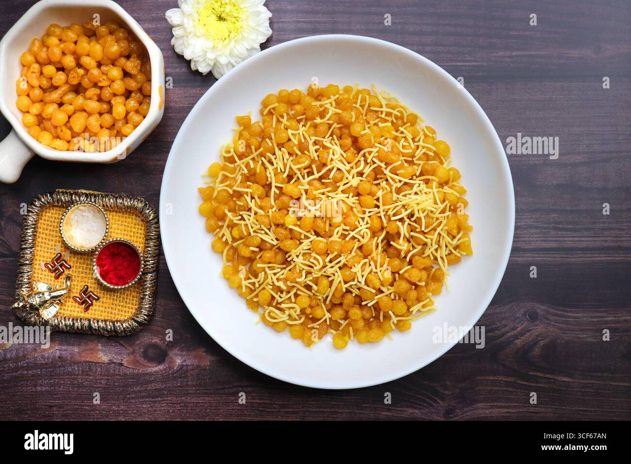 A close up of traditional Indian snacks. crispy savory sev and sweet ...