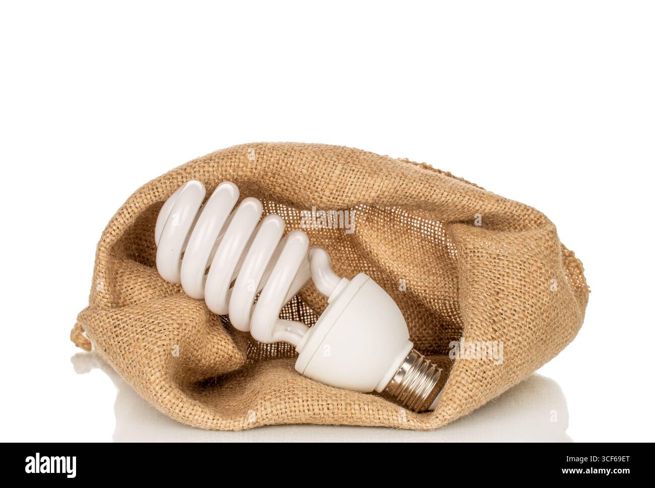 One LED lamp in a jute bag, close-up, isolated on a white background ...