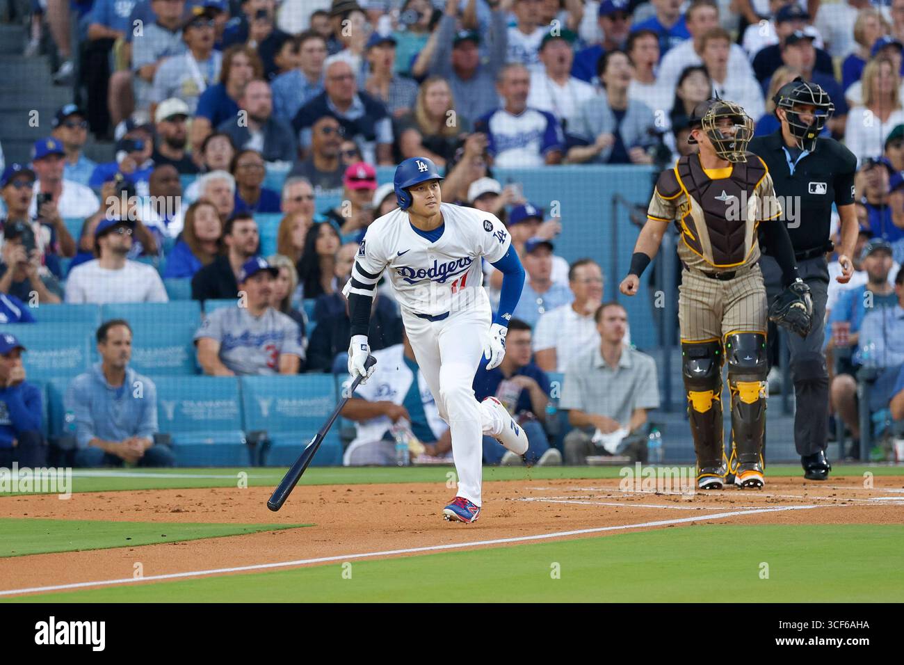 Shohei Ohtani #17 of the Los Angeles Dodgers runs up the line on a line ...