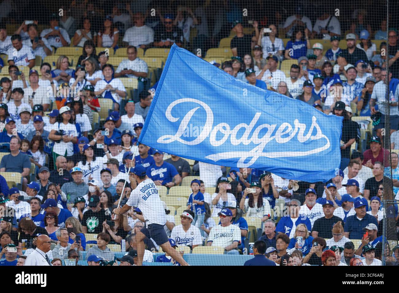 A Los Angeles Dodgers flag is waved prior to a game between the Los ...