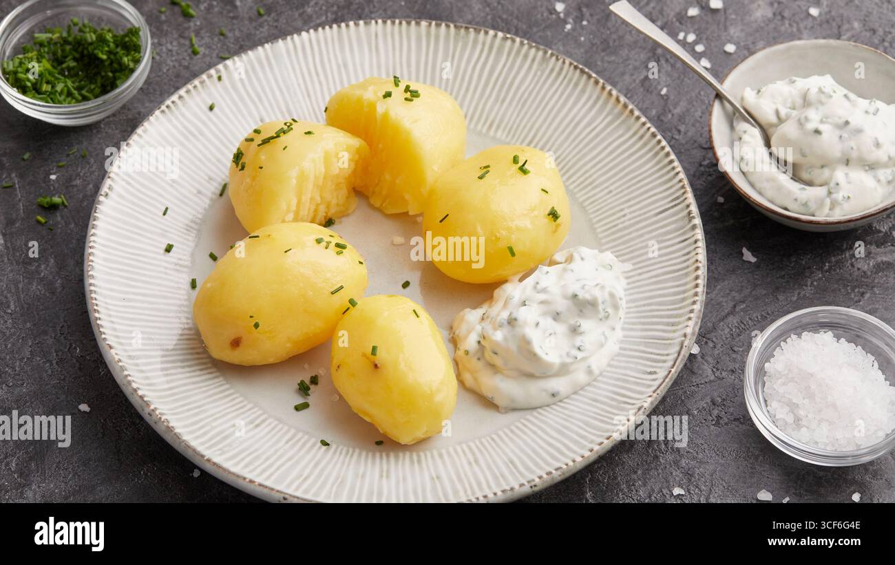 Boiled potatoes with chive dip Stock Photo - Alamy
